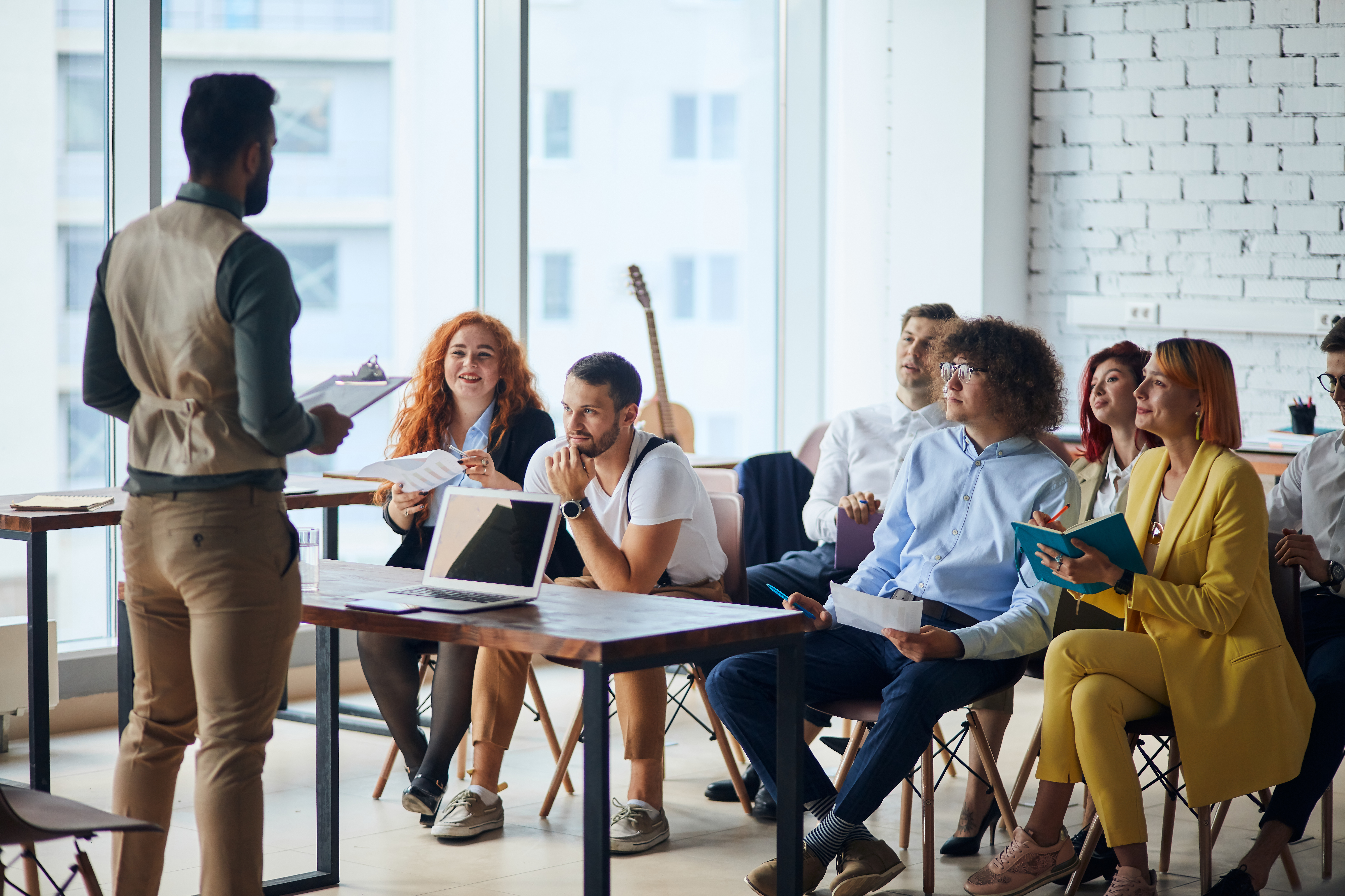Experienced young business coach giving presentation to executive ... Experienced young business coach giving presentation to executive ...